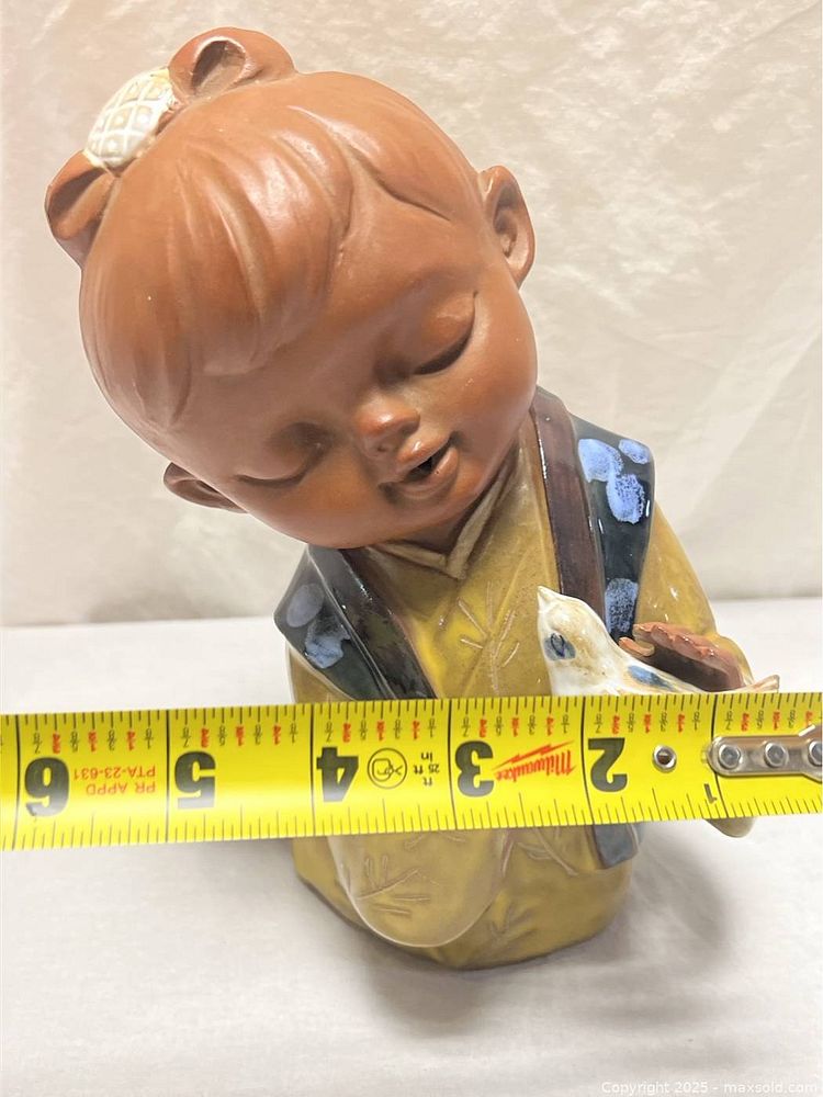 9" hand-painted ceramic child figurine holding bird | Maxsold