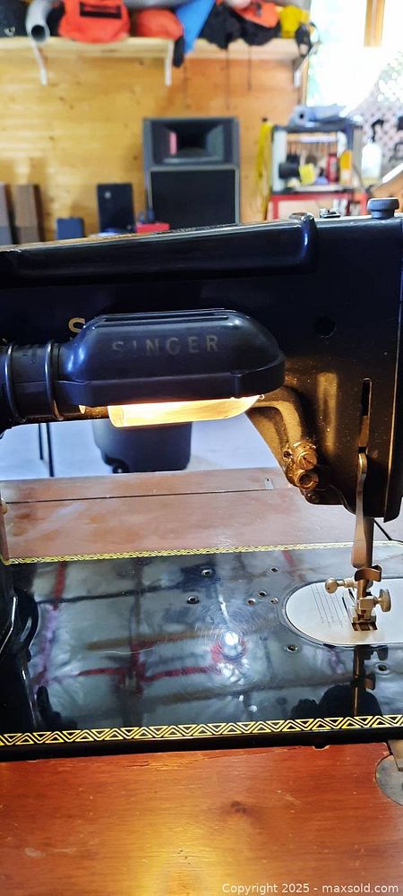 Singer 201-3 electric sewing machine with knee lever cabinet | Maxsold