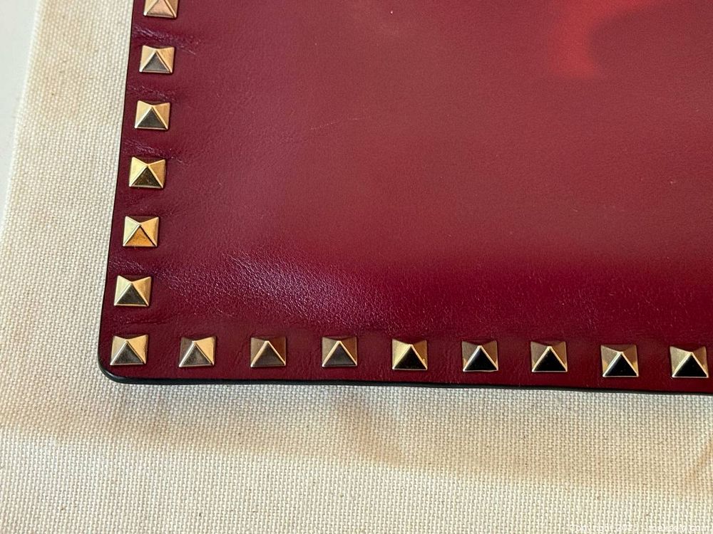 Valentino burgundy studded leather pouch | Maxsold