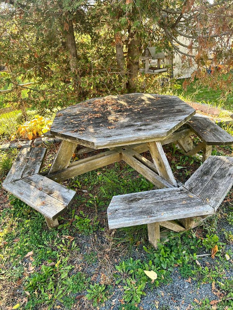Octagonal wooden picnic table, attached benches | Maxsold