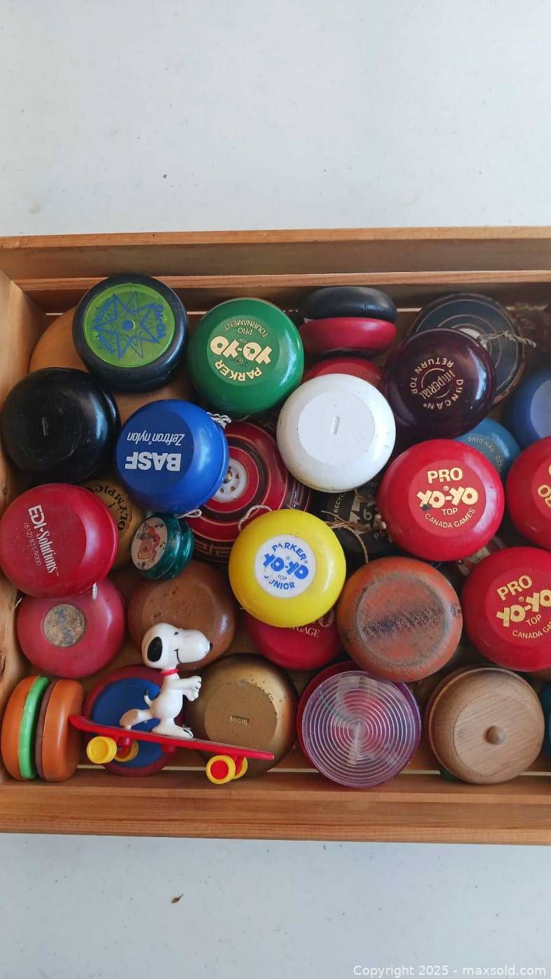Box of Yo-Yos and Snoopy on Skateboard | Maxsold
