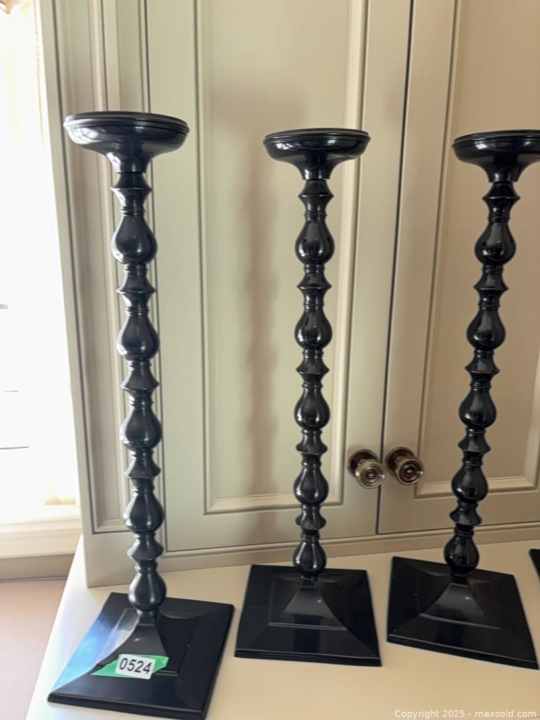 Tall black metal candlesticks, set of four | Maxsold