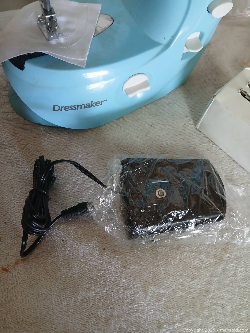 Dressmaker portable sewing machine with accessories | Maxsold