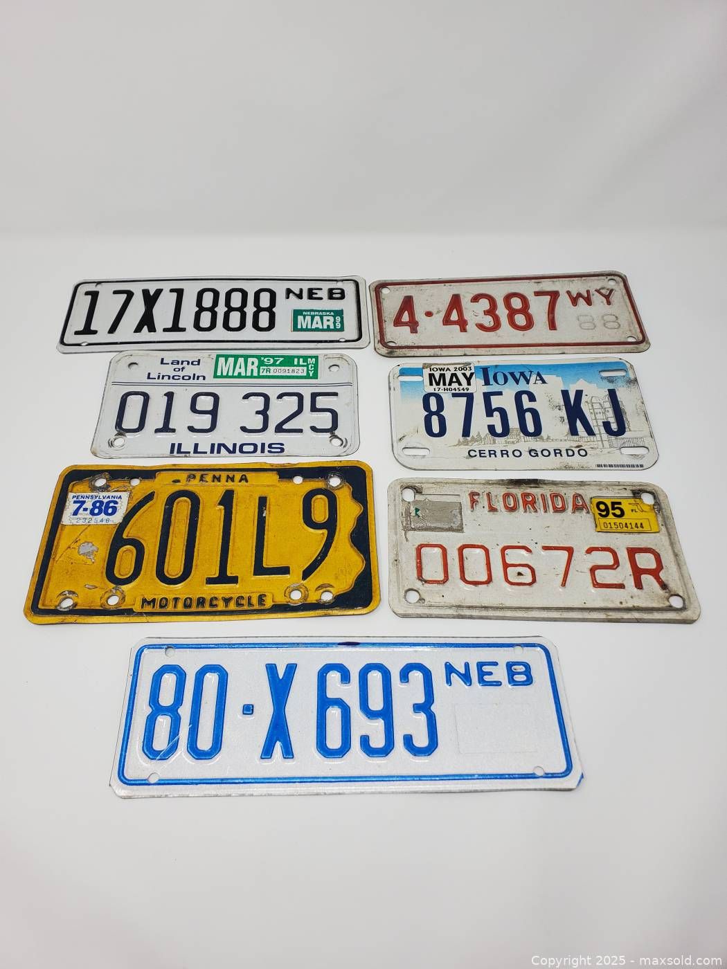 Seven vintage motorcycle license plates | Maxsold