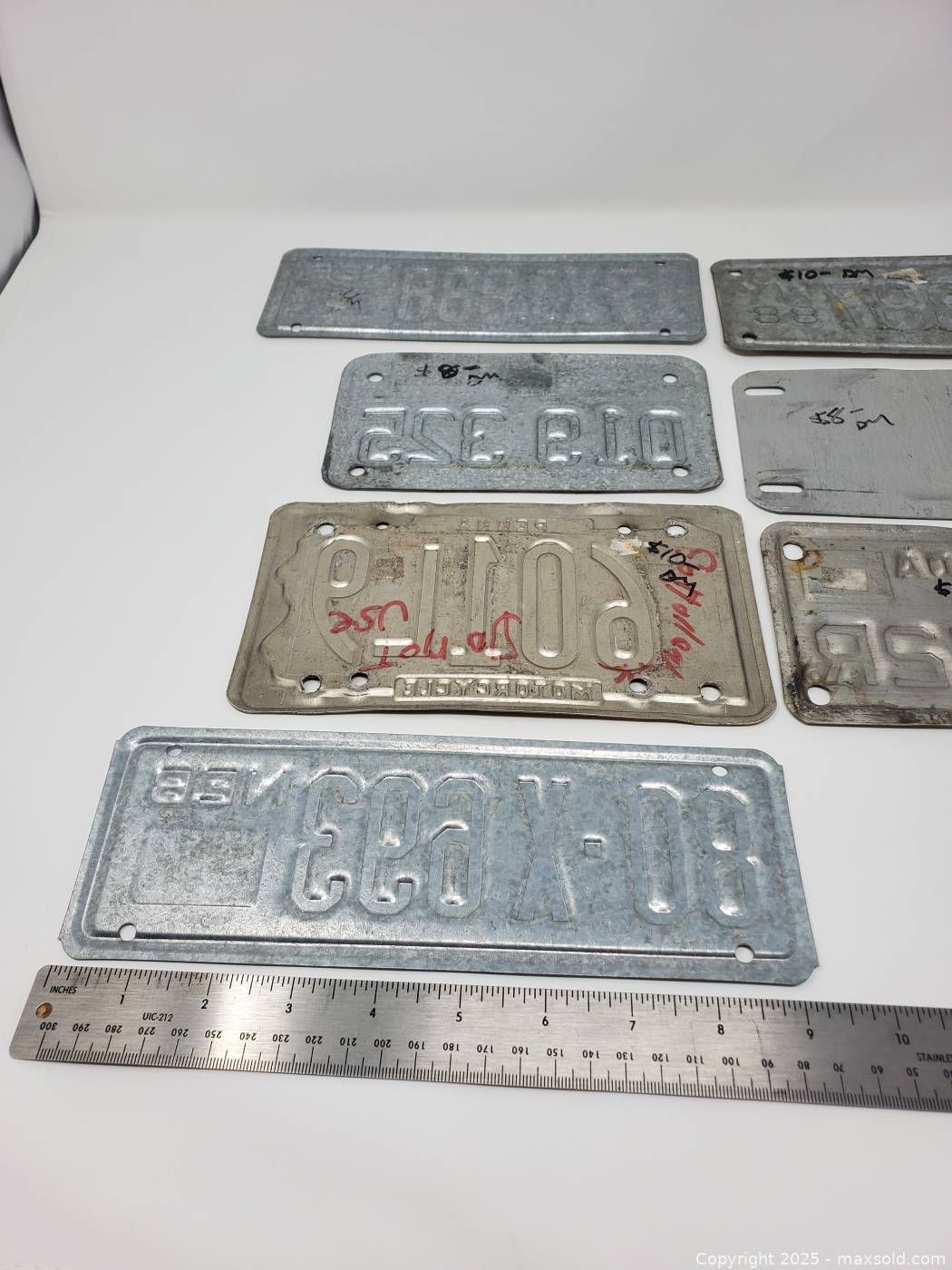 Seven vintage motorcycle license plates | Maxsold