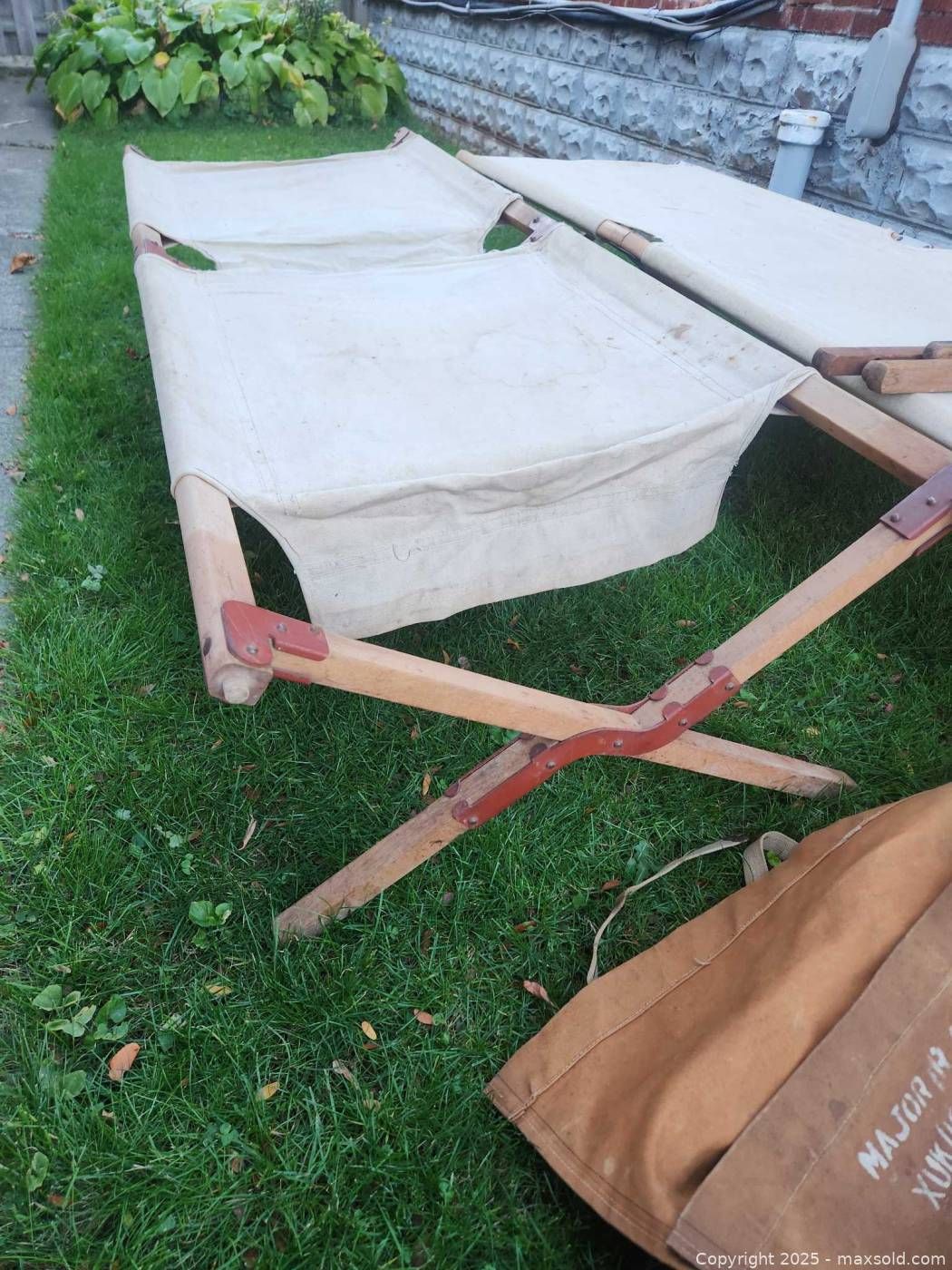 Two wooden military folding cots with canvas bag | Maxsold