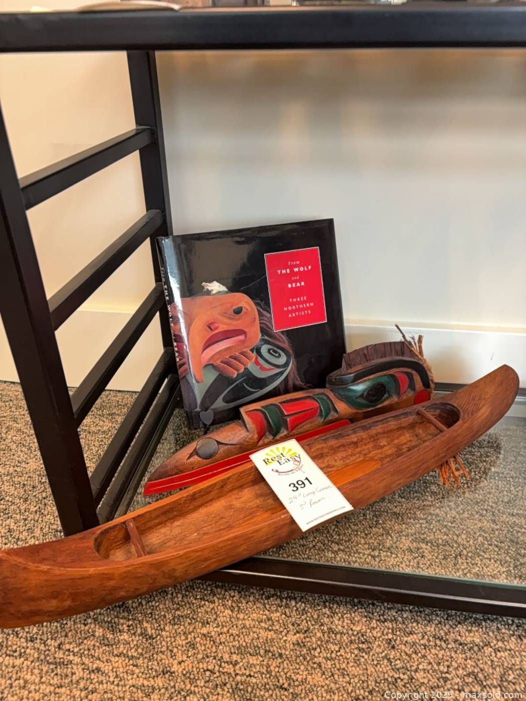 Carved 24" wooden canoe & Indigenous art book | Maxsold
