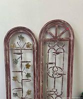 Pair of arched metal window-style plant holders | Maxsold