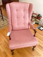 Pink upholstered wingback armchair | Maxsold