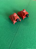 Pair of red metal model train bumpers | Maxsold
