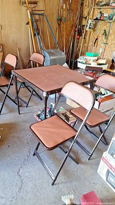 Brown folding card table with 4 padded chairs | Maxsold