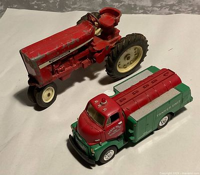 Vintage metal farm tractor and North Pole tanker truck | Maxsold