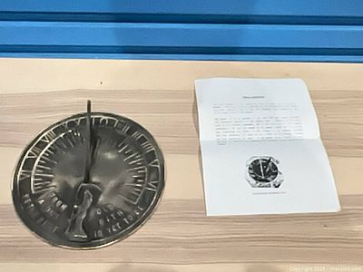 Cast metal sundial with instructions | Maxsold