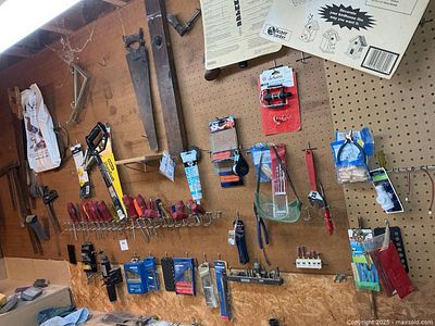 Wall-mounted assortment of hand tools and bits | Maxsold
