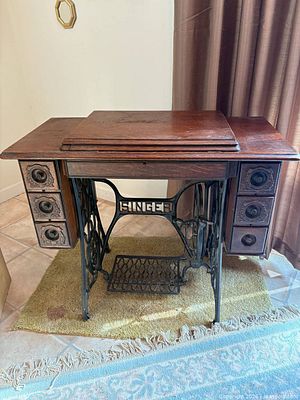 Singer treadle sewing machine with oak cabinet | Maxsold