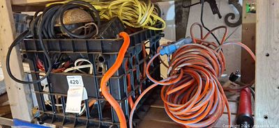 Assorted extension cords in crate | Maxsold