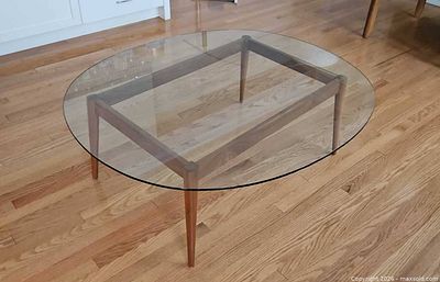 De Gaspe oval glass coffee table | Maxsold