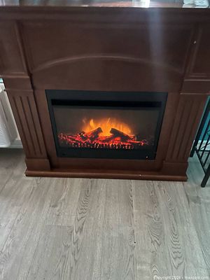 Electric fireplace with wooden mantel | Maxsold