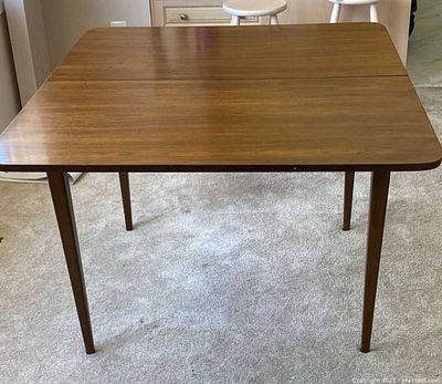 Mid-Century Modern walnut dining table | Maxsold