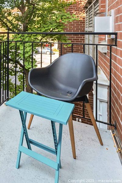Outdoor black chair and blue plastic side table | Maxsold