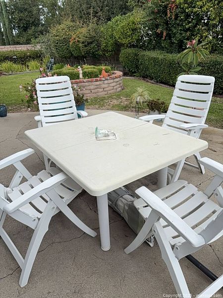 Plastic outdoor table with umbrella hole | Maxsold