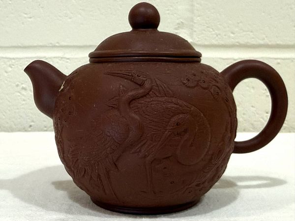 Yixing-style red clay teapot with crane relief | Maxsold