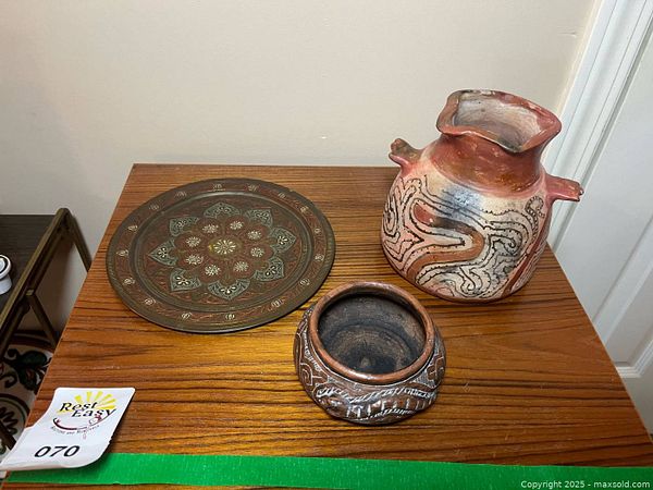 Decorative metal plate and two pottery vessels | Maxsold