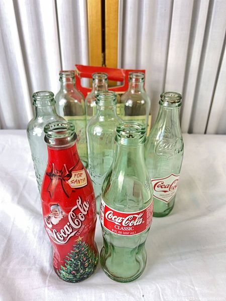 Eight empty Coca-Cola collectible glass bottles | Maxsold