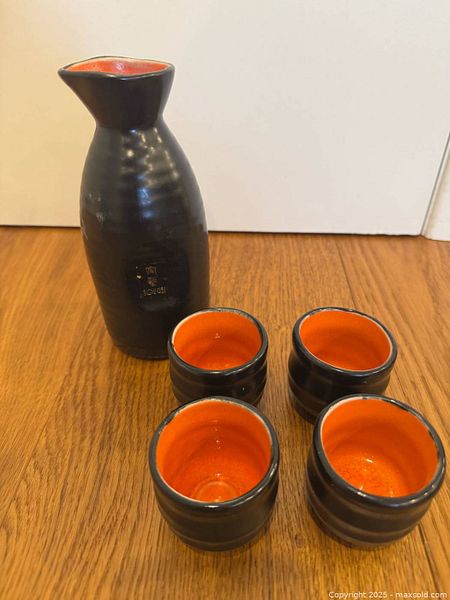 TOUGEI matte black and orange ceramic sake set | Maxsold