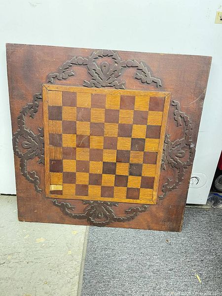 Vintage wooden checkers board with carved frame | Maxsold