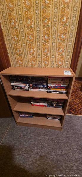 3-shelf laminate bookcase with VHS tapes | Maxsold