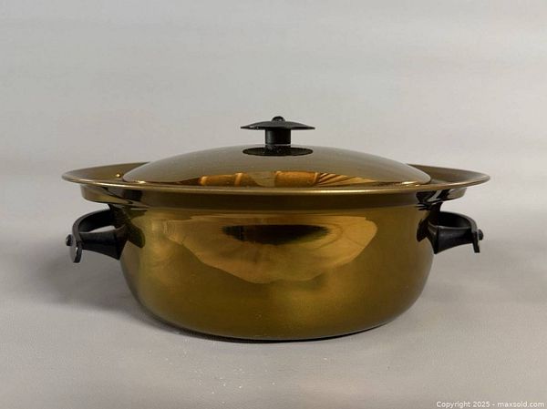 Pyrex glass casserole with gold-tone aluminum holder and lid | Maxsold