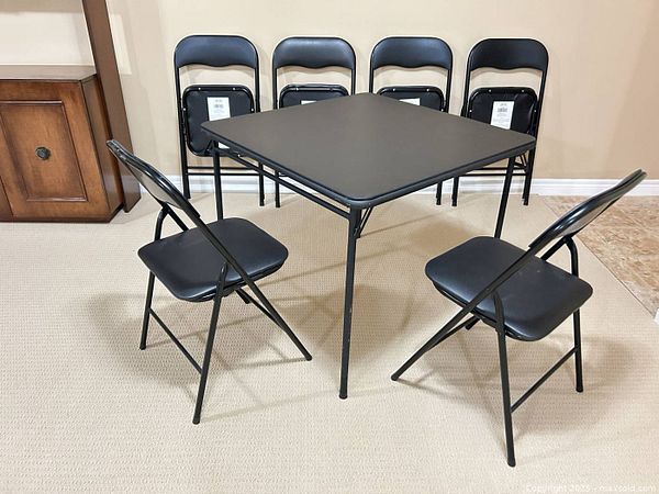Black square folding table with six folding chairs | Maxsold