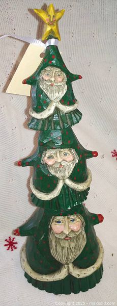 Wood carved Santa faces Christmas tree totem | Maxsold