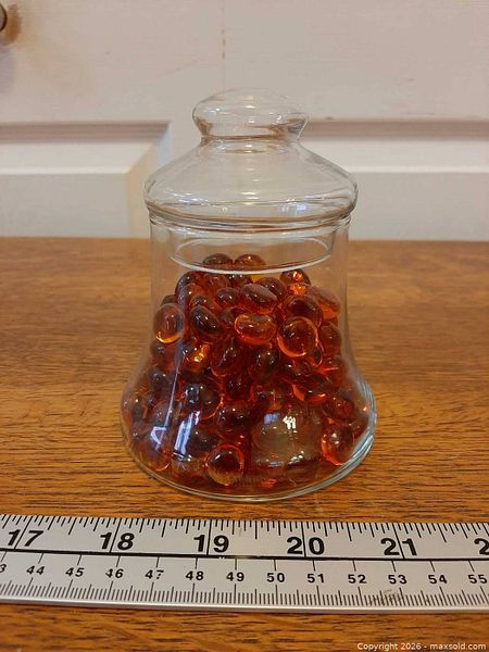 Apothecary jar with amber fire glass pebbles | Maxsold