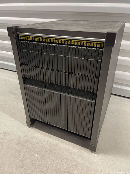 Plastic LaserDisc storage rack with assorted karaoke discs | Maxsold