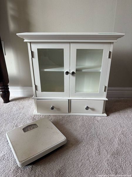 White bathroom cabinet & Danze scale | Maxsold