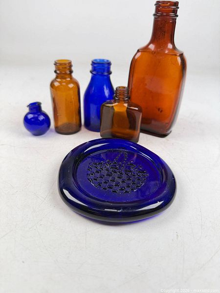 Brown and cobalt glass bottles with cobalt paperweight | Maxsold