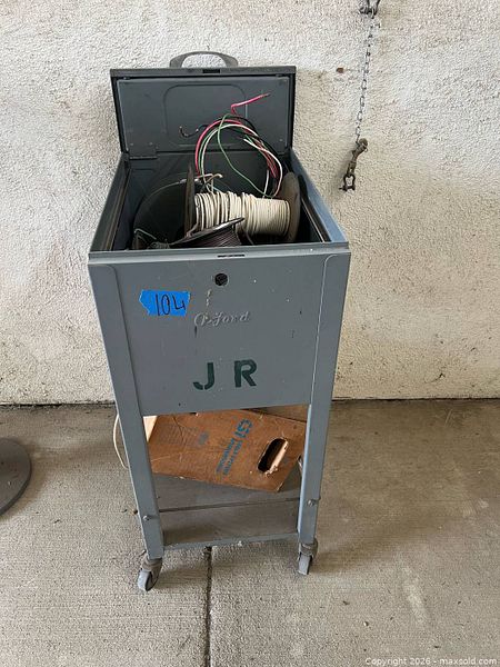 Rolling metal cart with multiple spools of insulated electrical wire ...