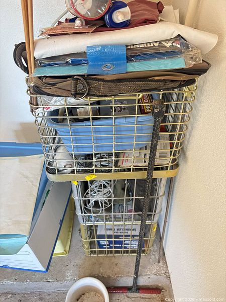 Metal wire cubby shelving with blue bins | Maxsold