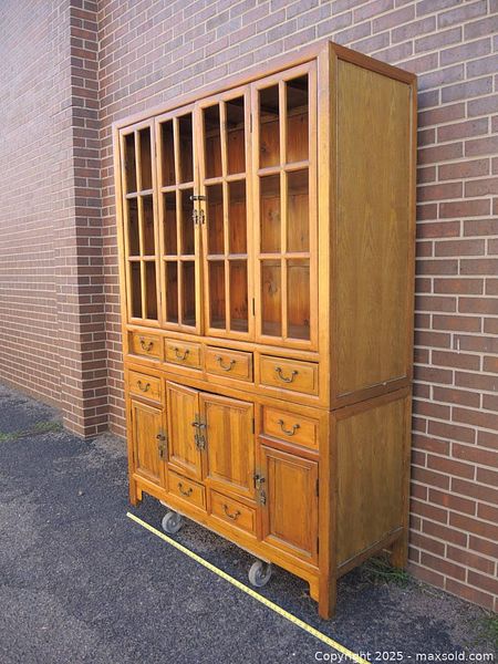 Antique Asian style two-piece wooden cabinet with brass hardware | Maxsold